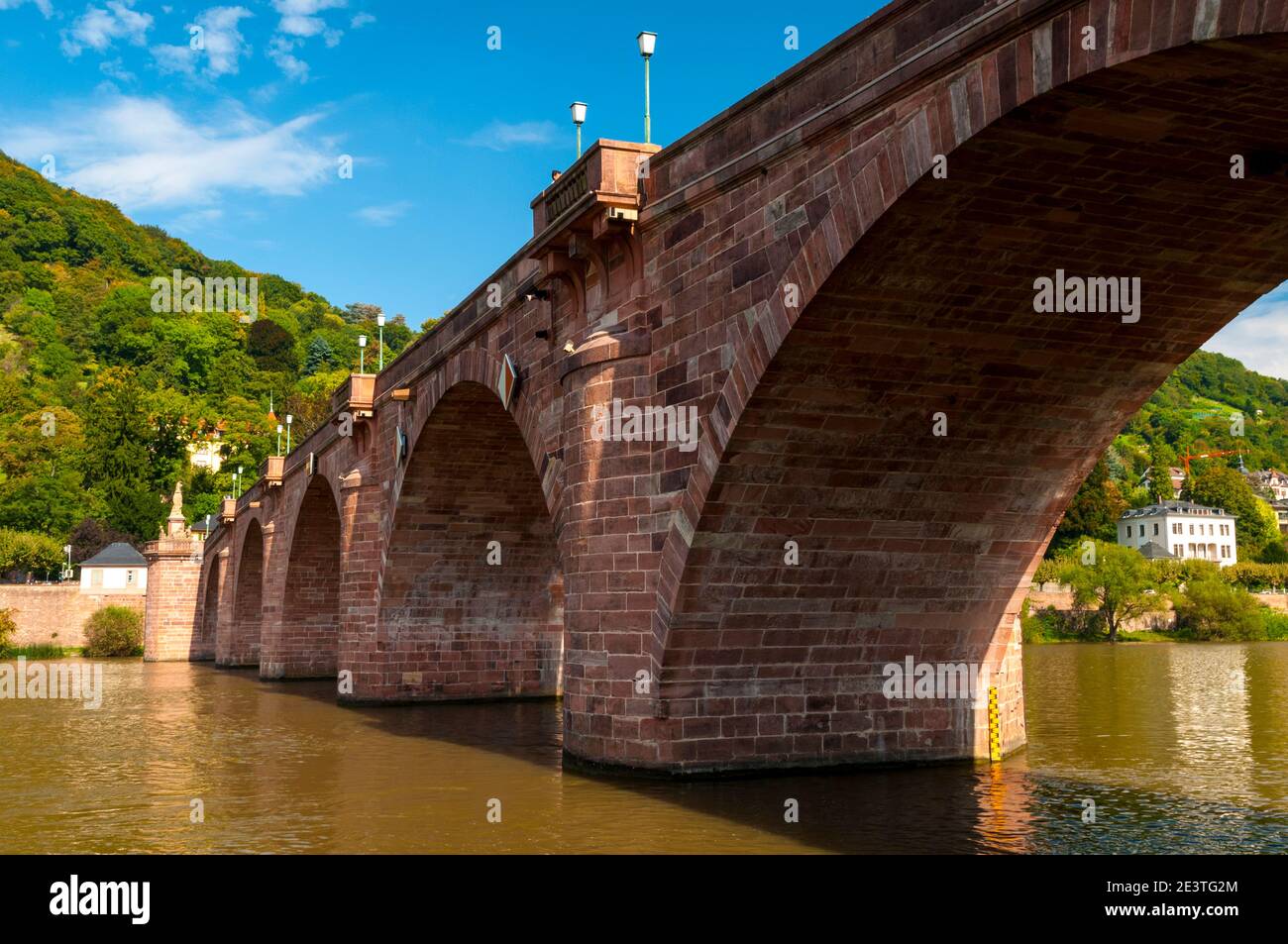 The arches of the Alte Brücke (old bridge) spanning the brown waters of ...
