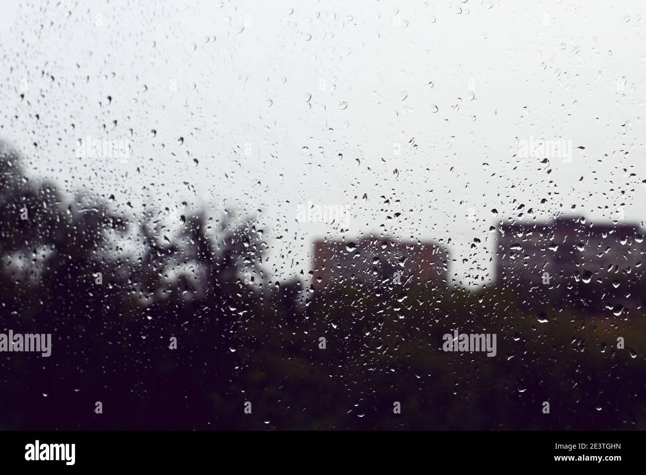 View from the window of apartment through the wet glass of window with ...