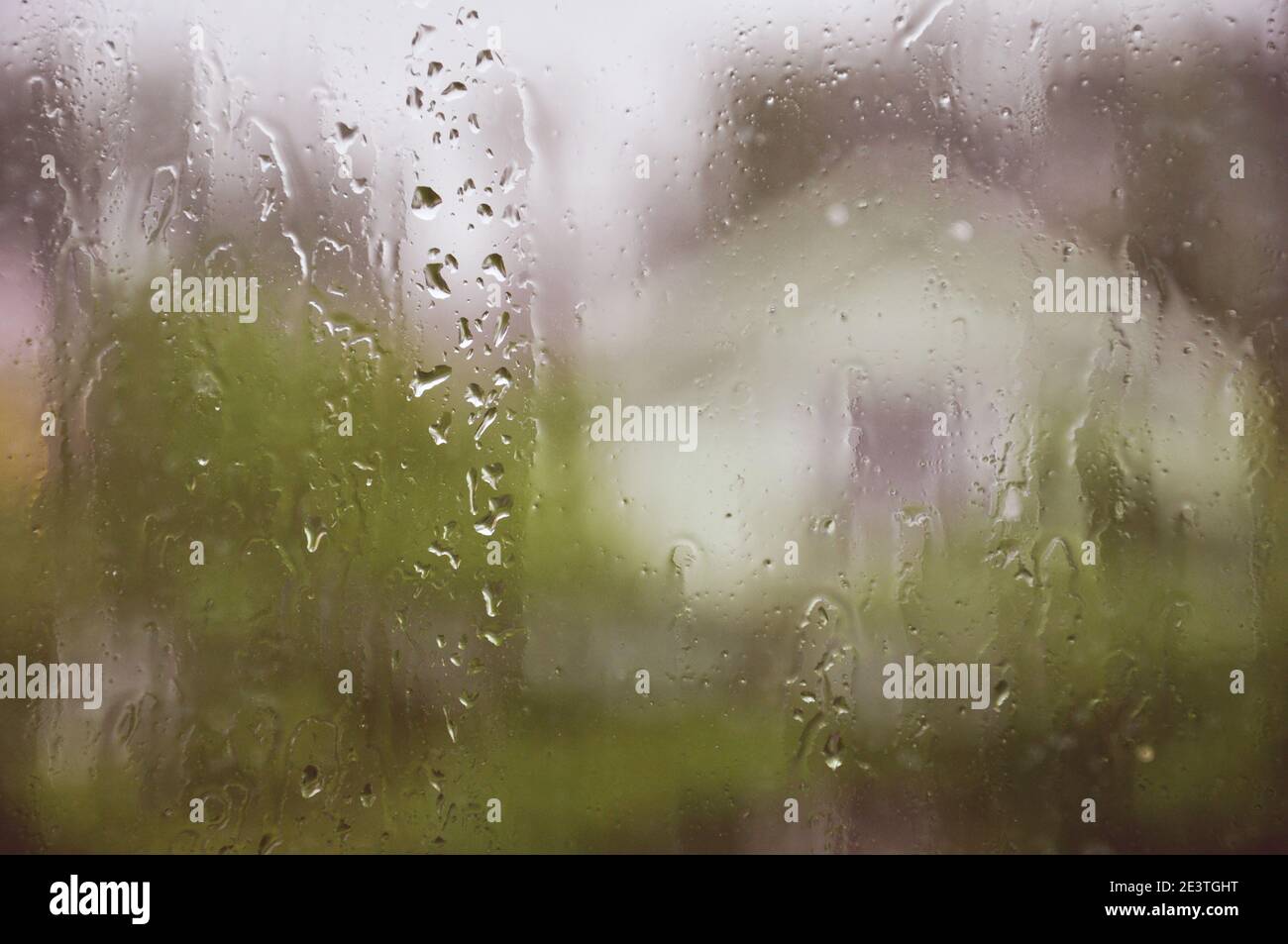 wet glass of window with raindrops, estate garden Stock Photo - Alamy