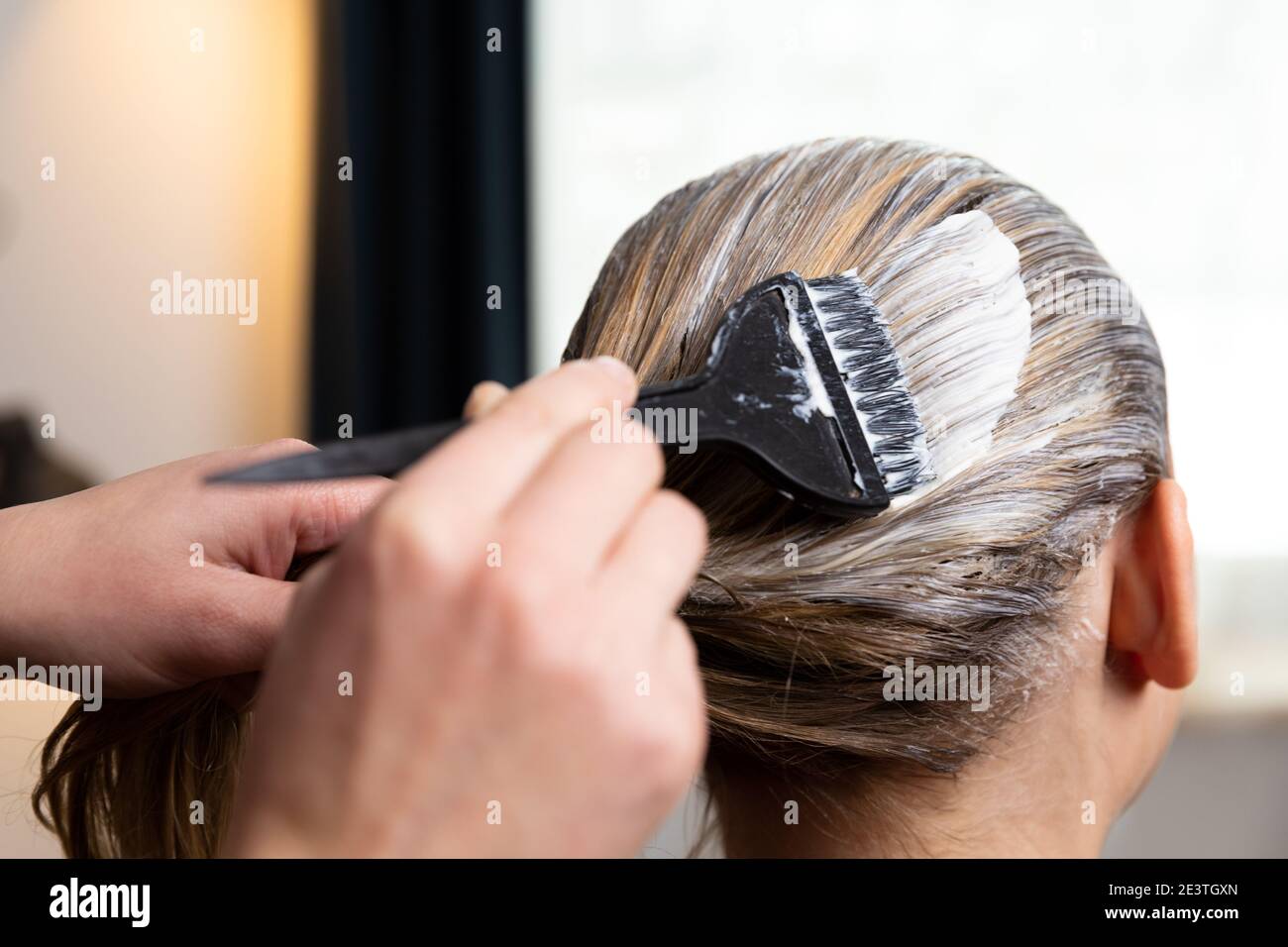Women in process of coloring hair to other women while staying at home ...