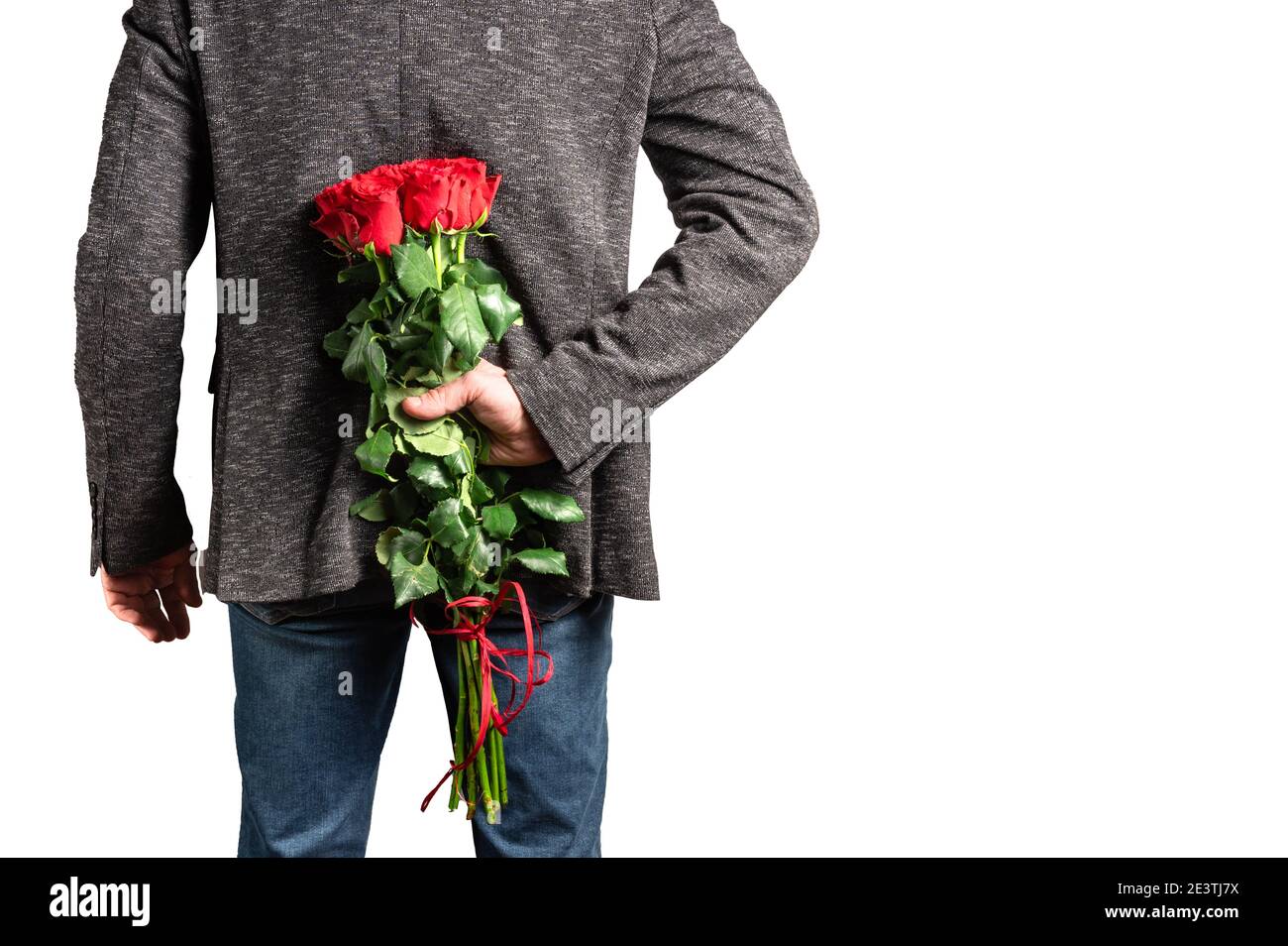 Man with a bouquet of red roses behind his back. Elegant man holding ...
