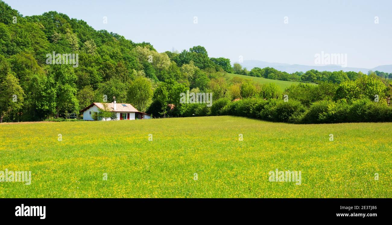 French Basque Country landscape with typical farmhouse and forested ...