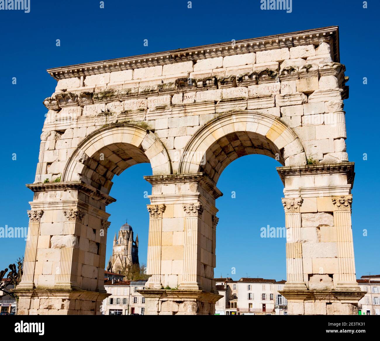 Ancient Roman arch (Arch of Germanicus) and cathedral Saint-Pierre seen ...