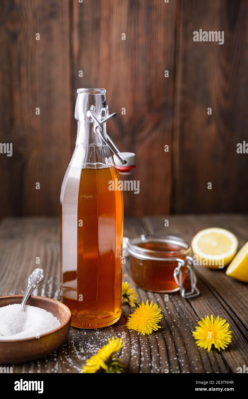Homemade healthy dandelion syrup in a glass bottle, decorated with ...