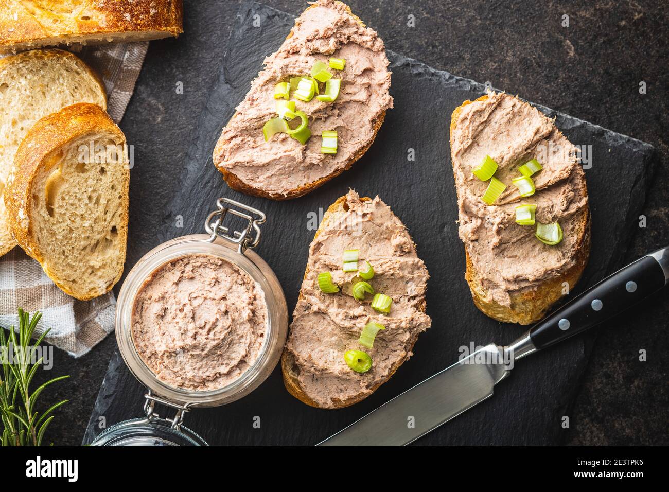 Liver pate on sliced baguette on cutting board. Top view Stock Photo ...