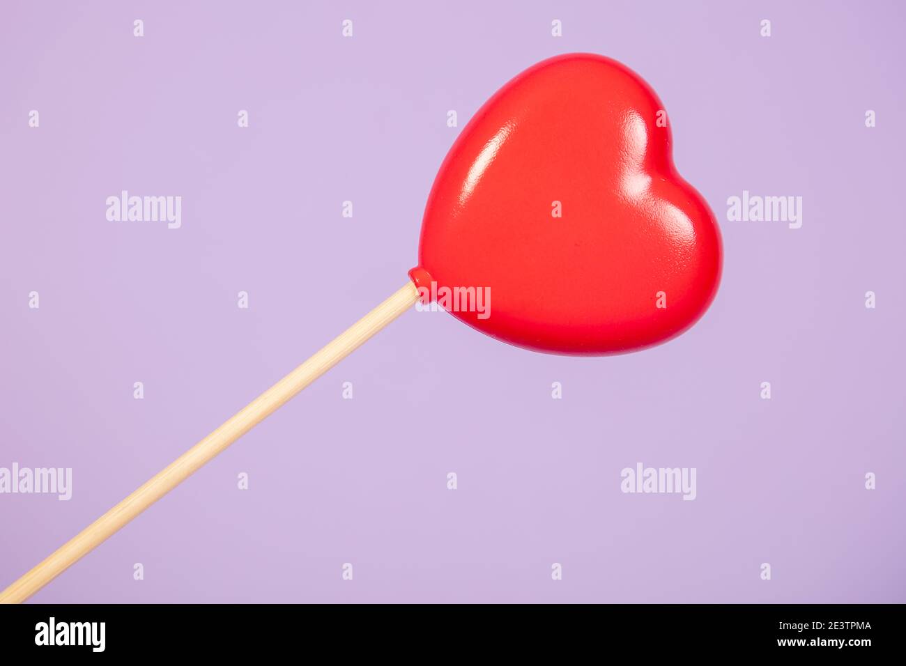 heart on a stick, isolated on purple background Stock Photo - Alamy