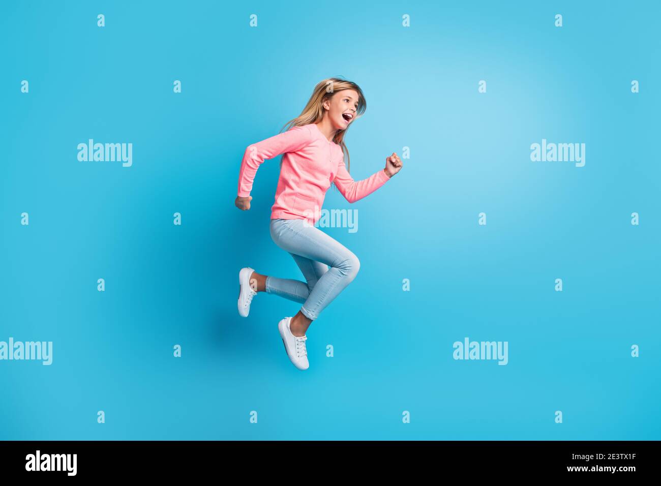 Photo portrait of girl jumping up running isolated on pastel blue ...