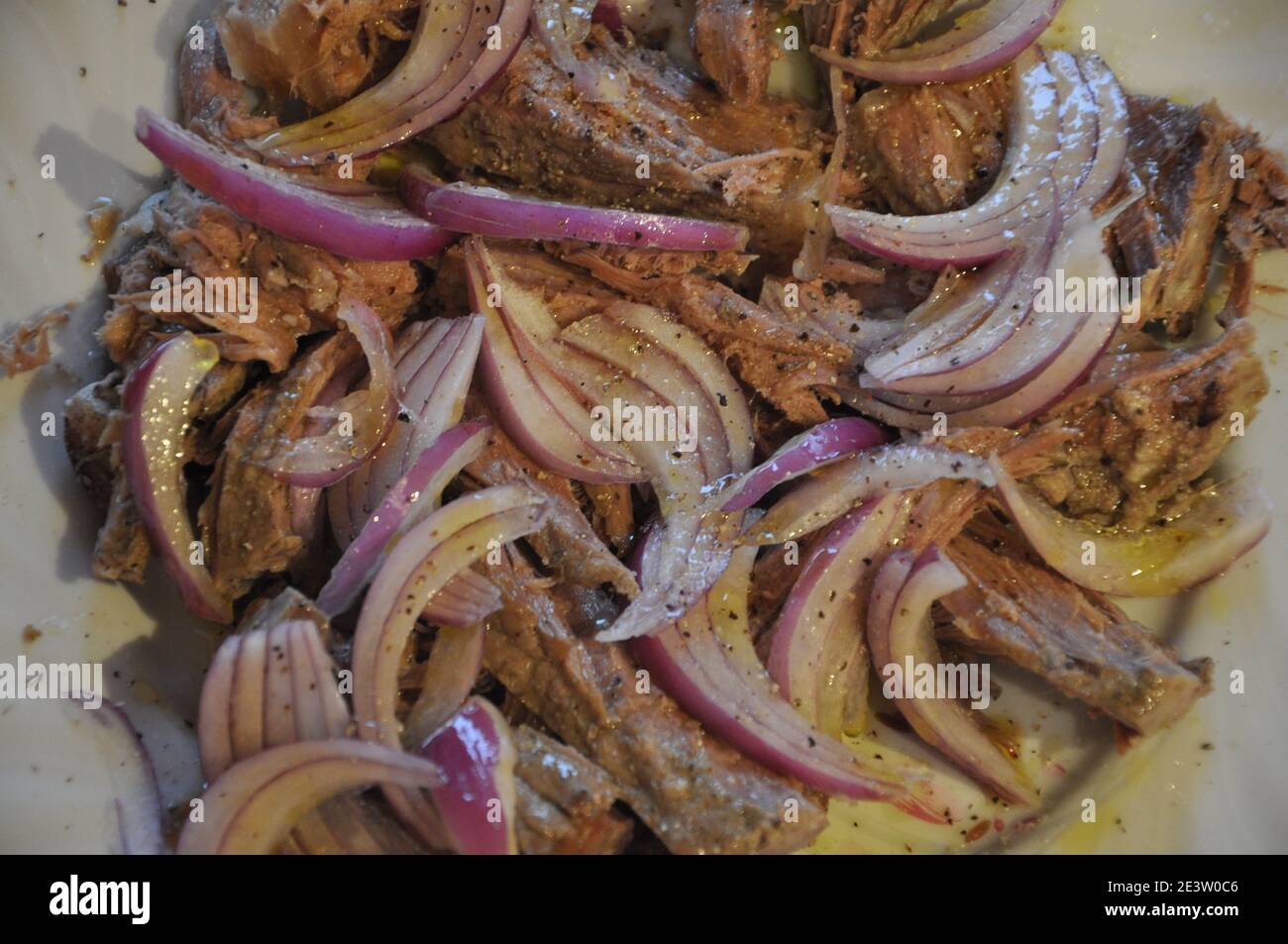 Gourmet cold boiled beef salad with onion and olive oil on the plate ...