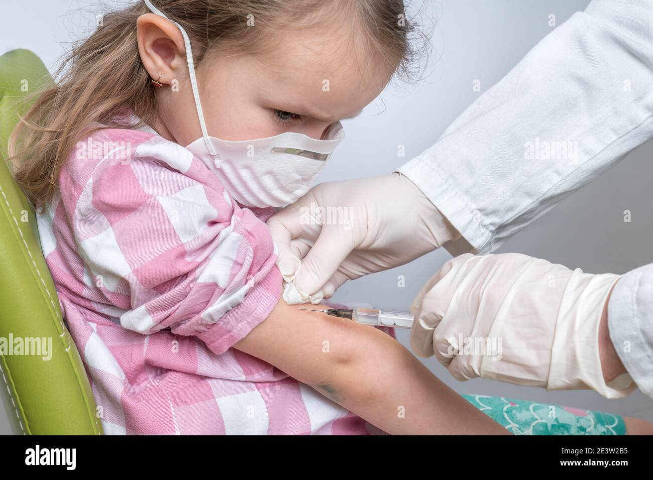 Doctor vaccinating a baby girl to protect against Covid-19 ...
