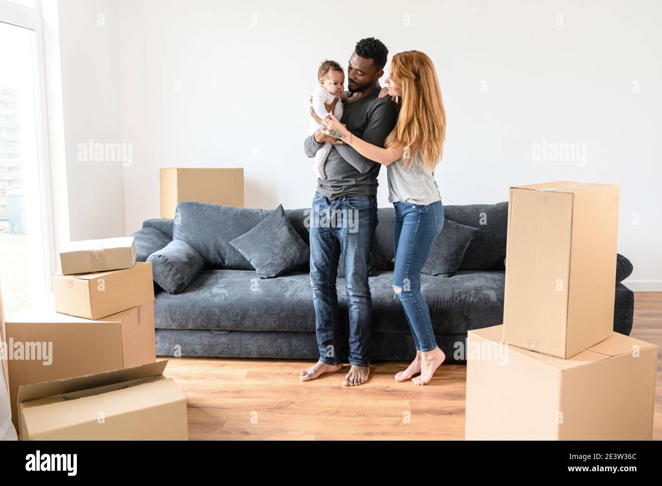 Multiracial family moving in a new house Stock Photo - Alamy