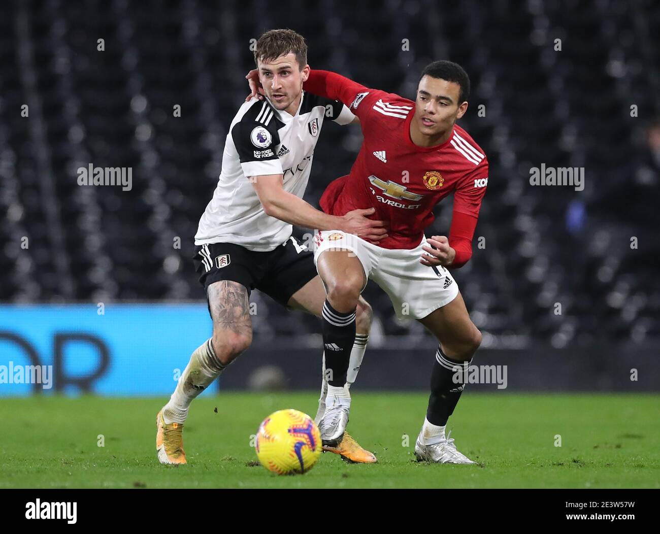 Fulham's Joe Bryan (left) and Manchester United's Mason Greenwood ...