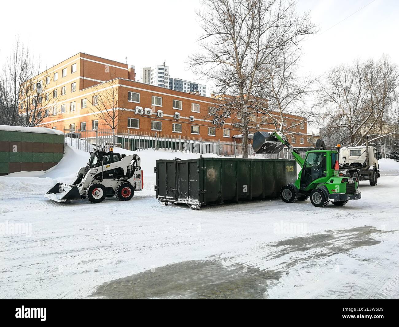Moscow. Russia. January 15, 2021. Small front-end loaders clear snow ...