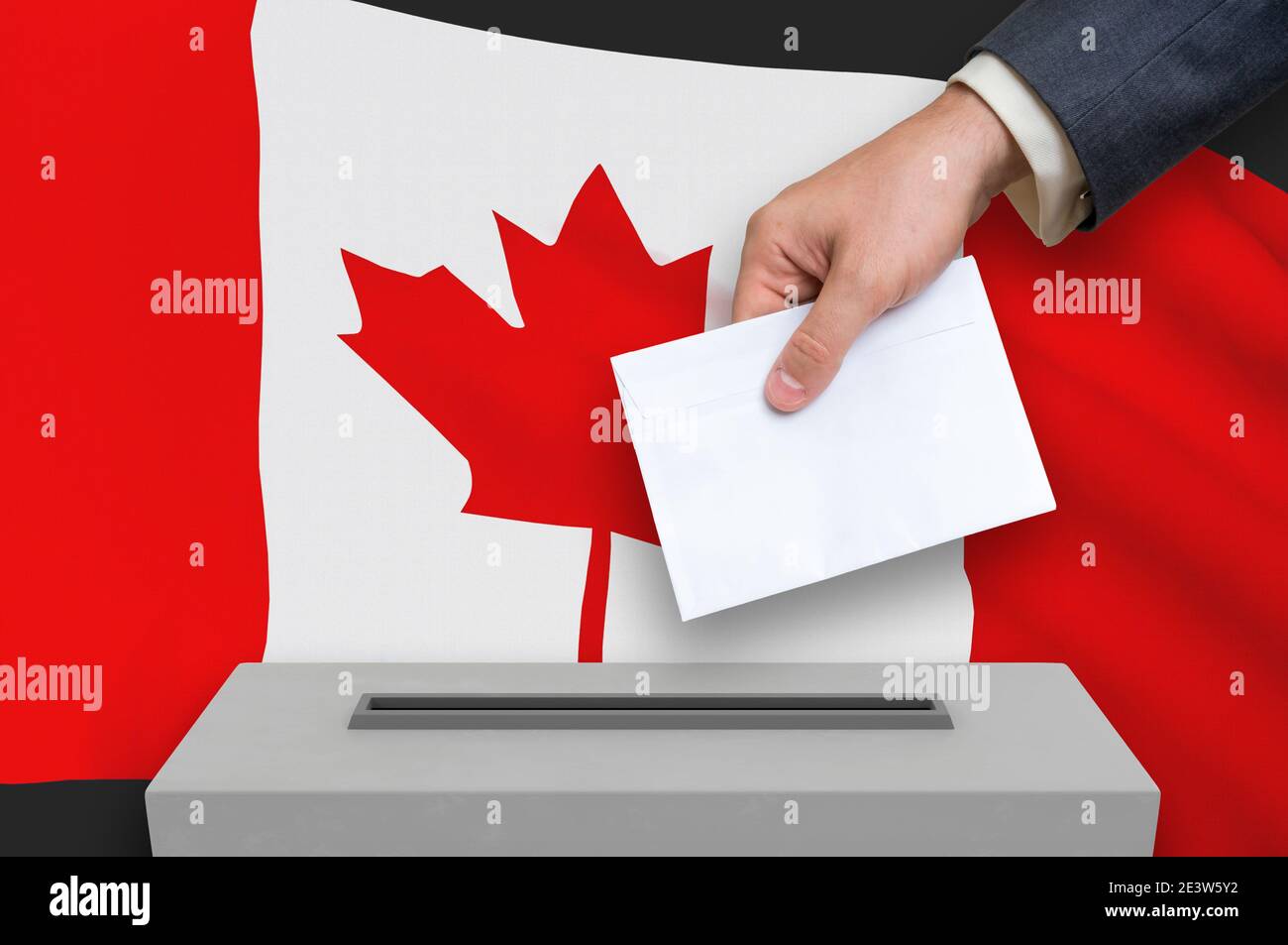 Election in Canada - voting at the ballot box. The hand of man is ...