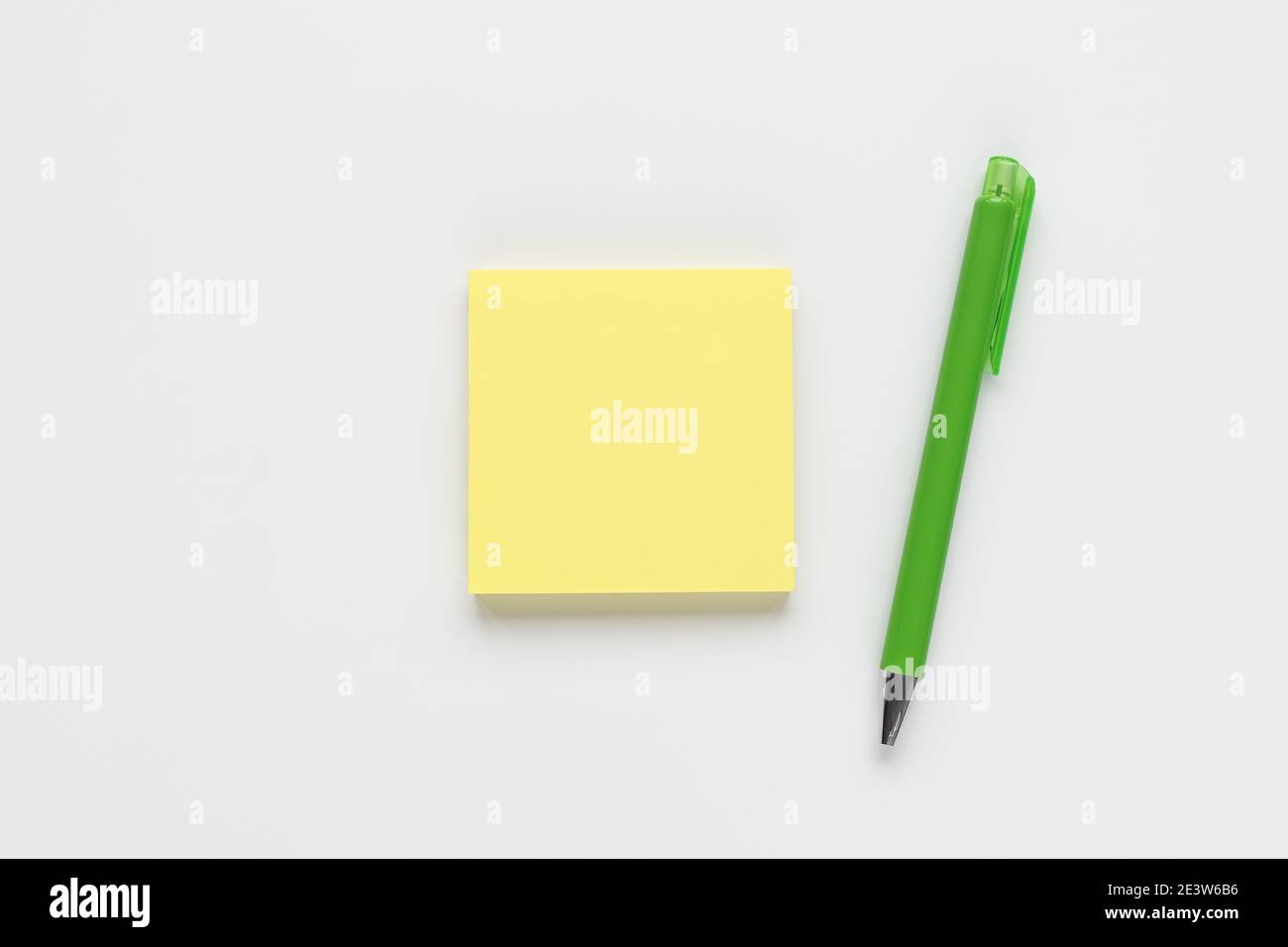 Self-stick yellow note pad or sticky note and pen Stock Photo - Alamy