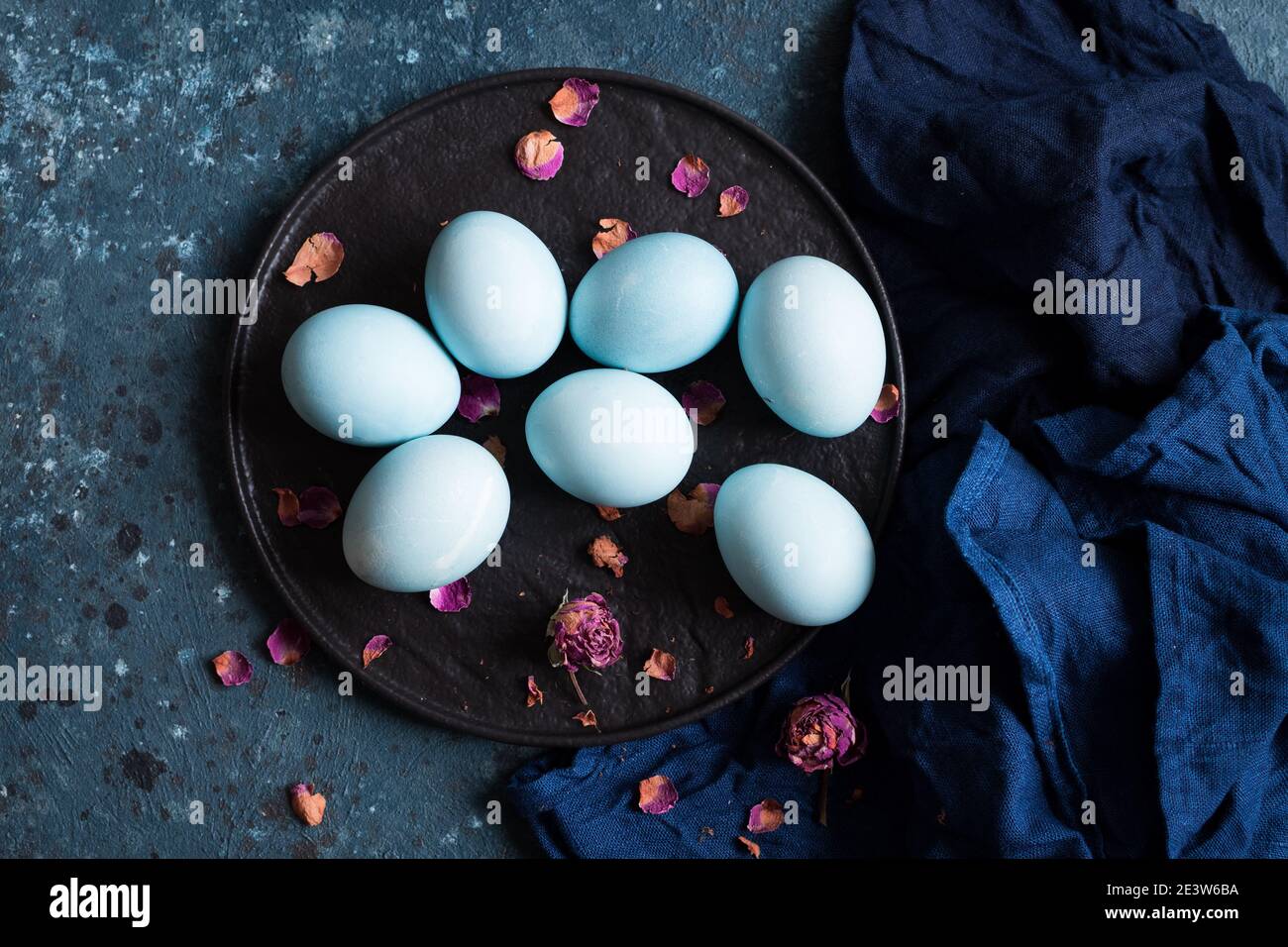 Blue Easter eggs painted with natural dye red cabbage on dark blue ...