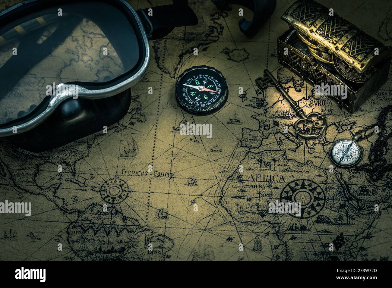 Old map with diving equipment. A treasure chest, a compass and a key ...