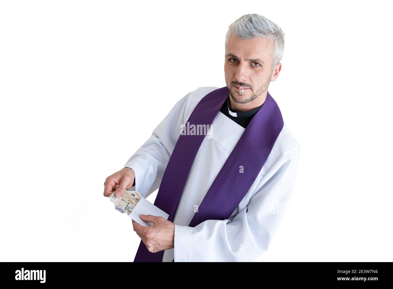 Polish catholic priest holding Polish money zloty during pastoral visit ...