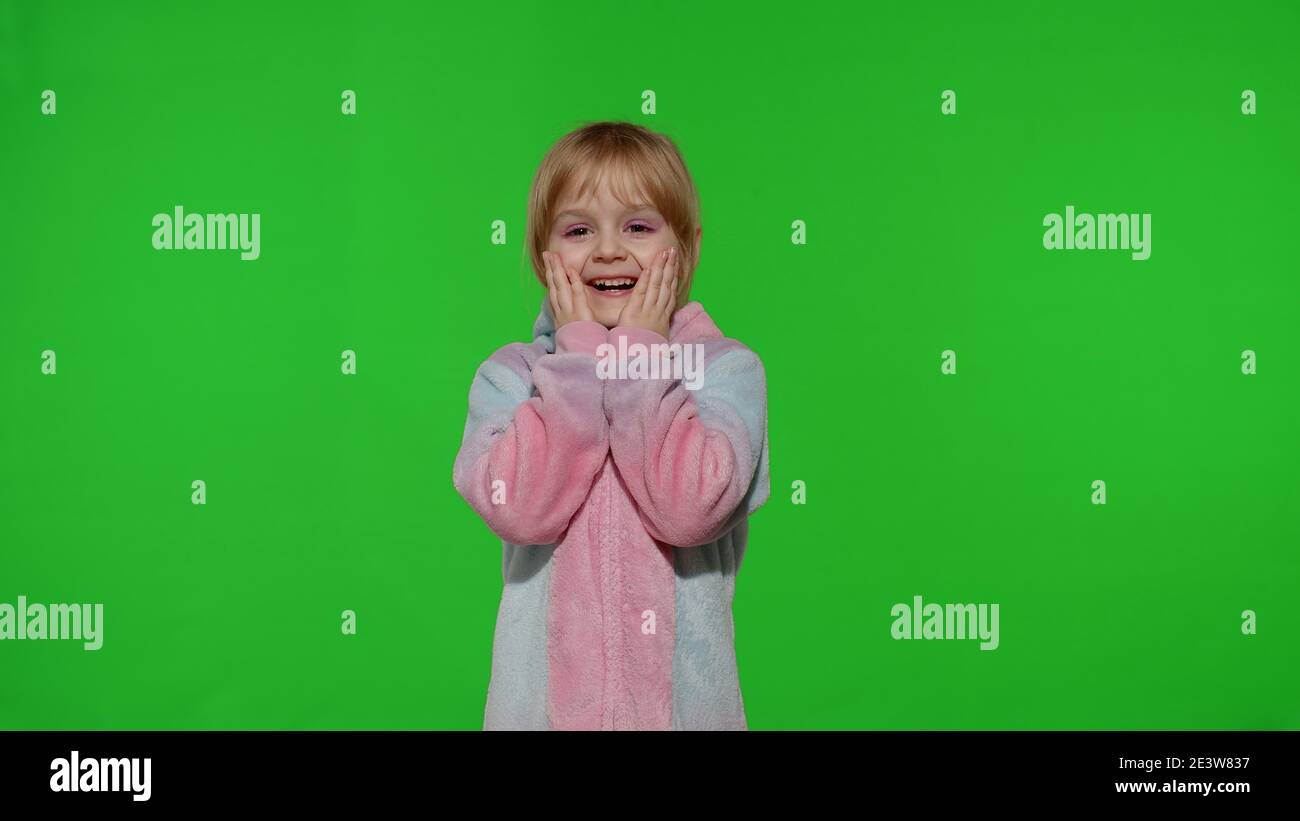 Portrait of happy amazed astonished young kid girl in unicorn costume ...