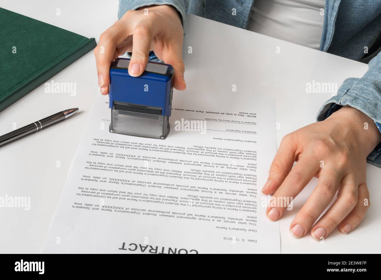 Business woman putting stamp on documents in the office - signing ...