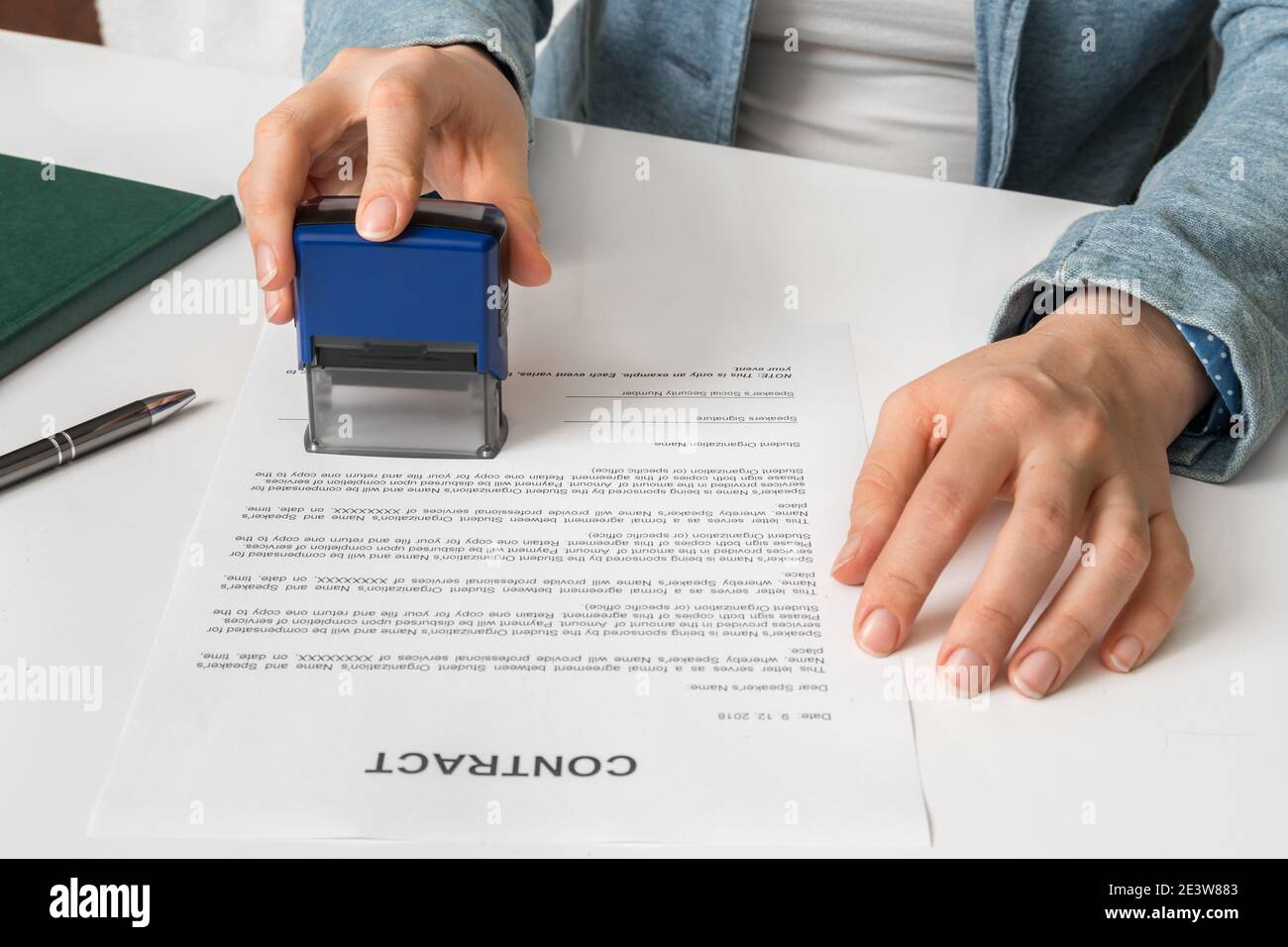 Business woman putting stamp on documents in the office - signing ...