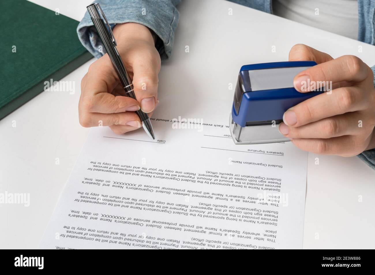 Business woman putting stamp on documents in the office - signing ...