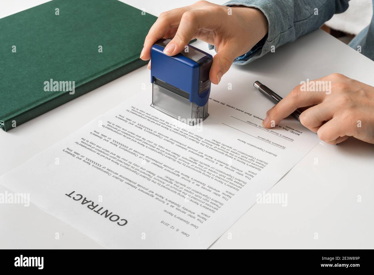 Business woman putting stamp on documents in the office - signing ...