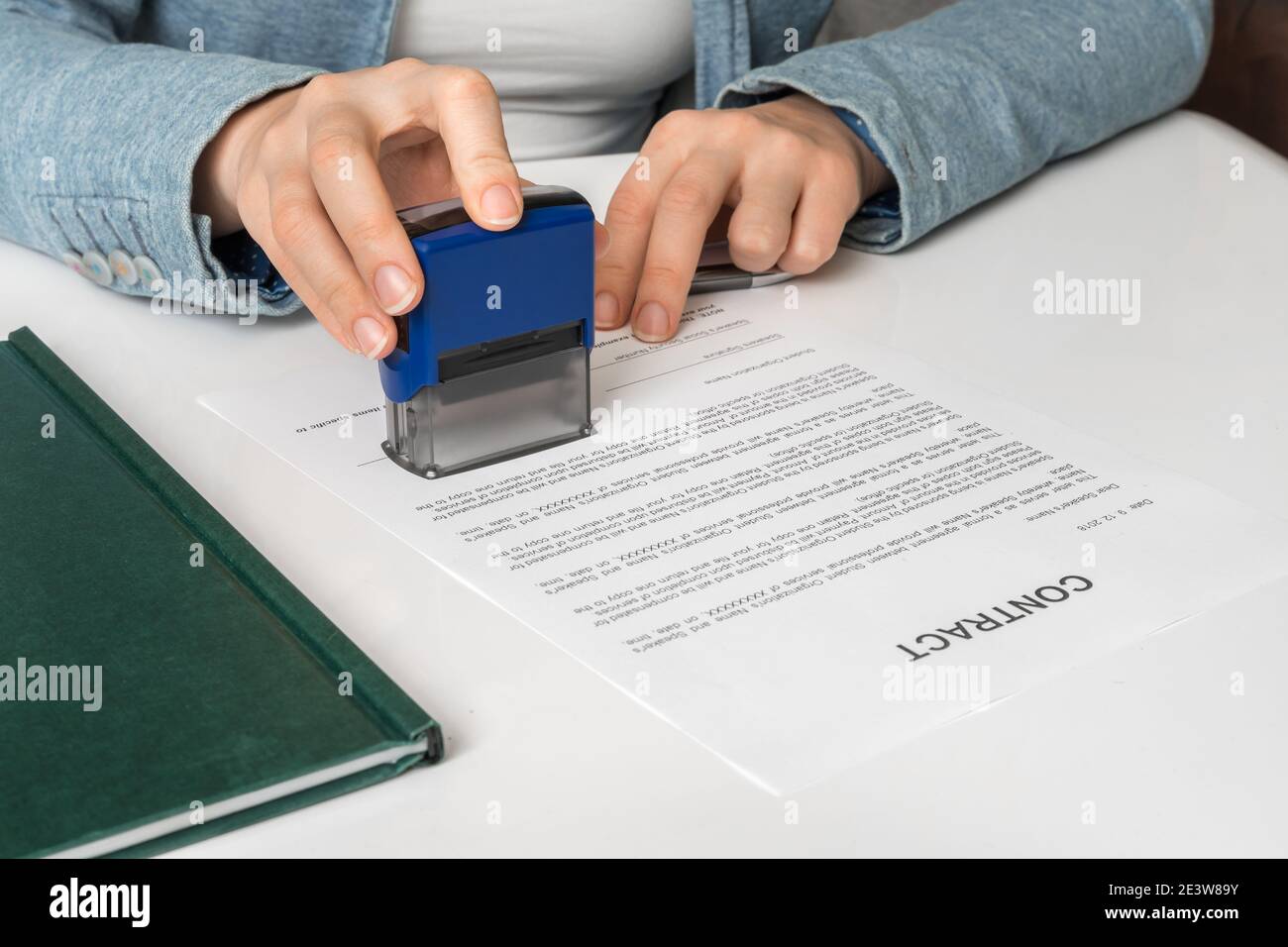 Business woman putting stamp on documents in the office - signing ...