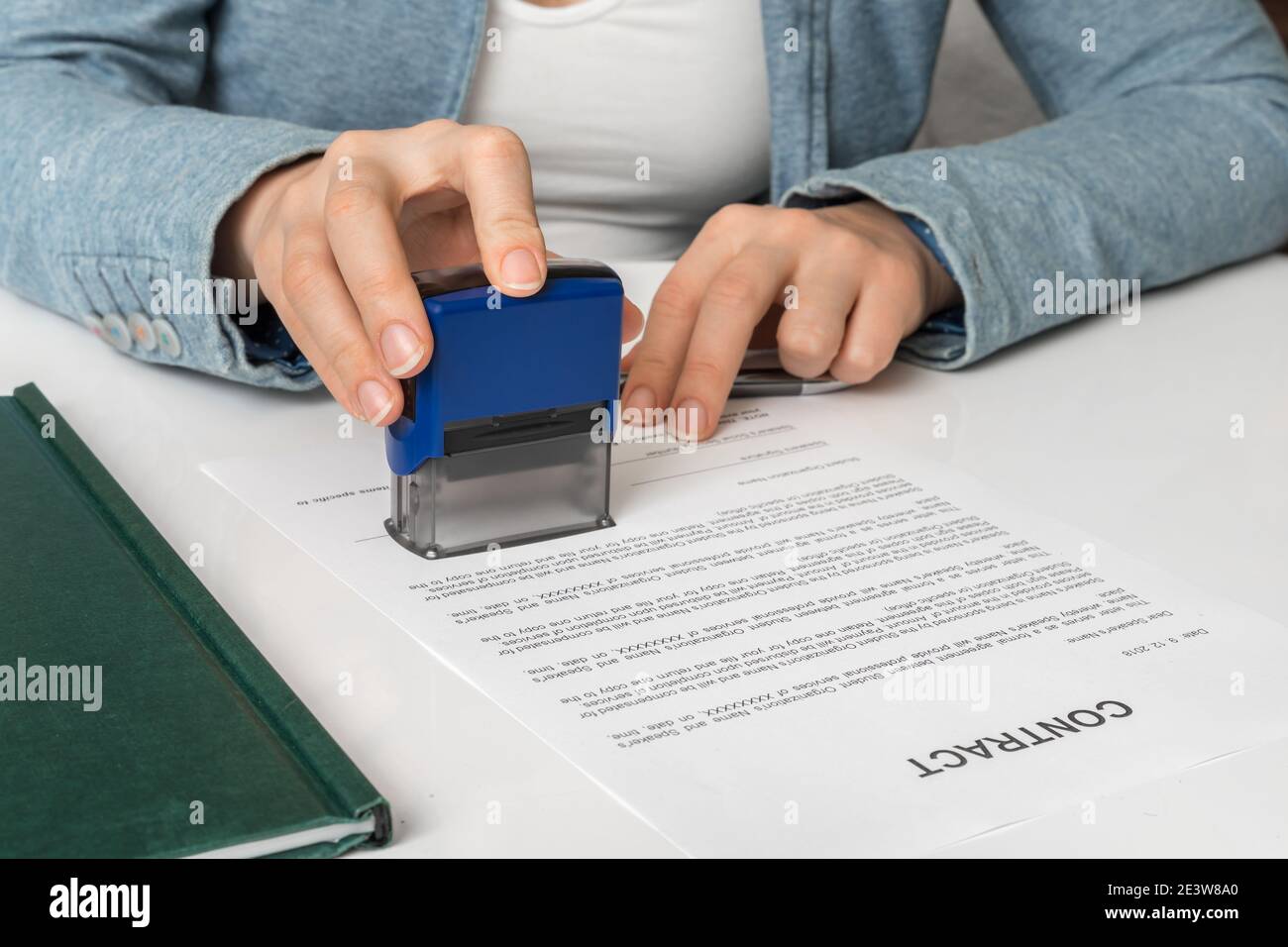 Business woman putting stamp on documents in the office - signing ...