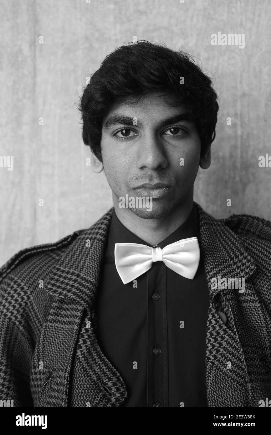 Portrait of stylish asian man wearing a white bow tie , London, UK ...
