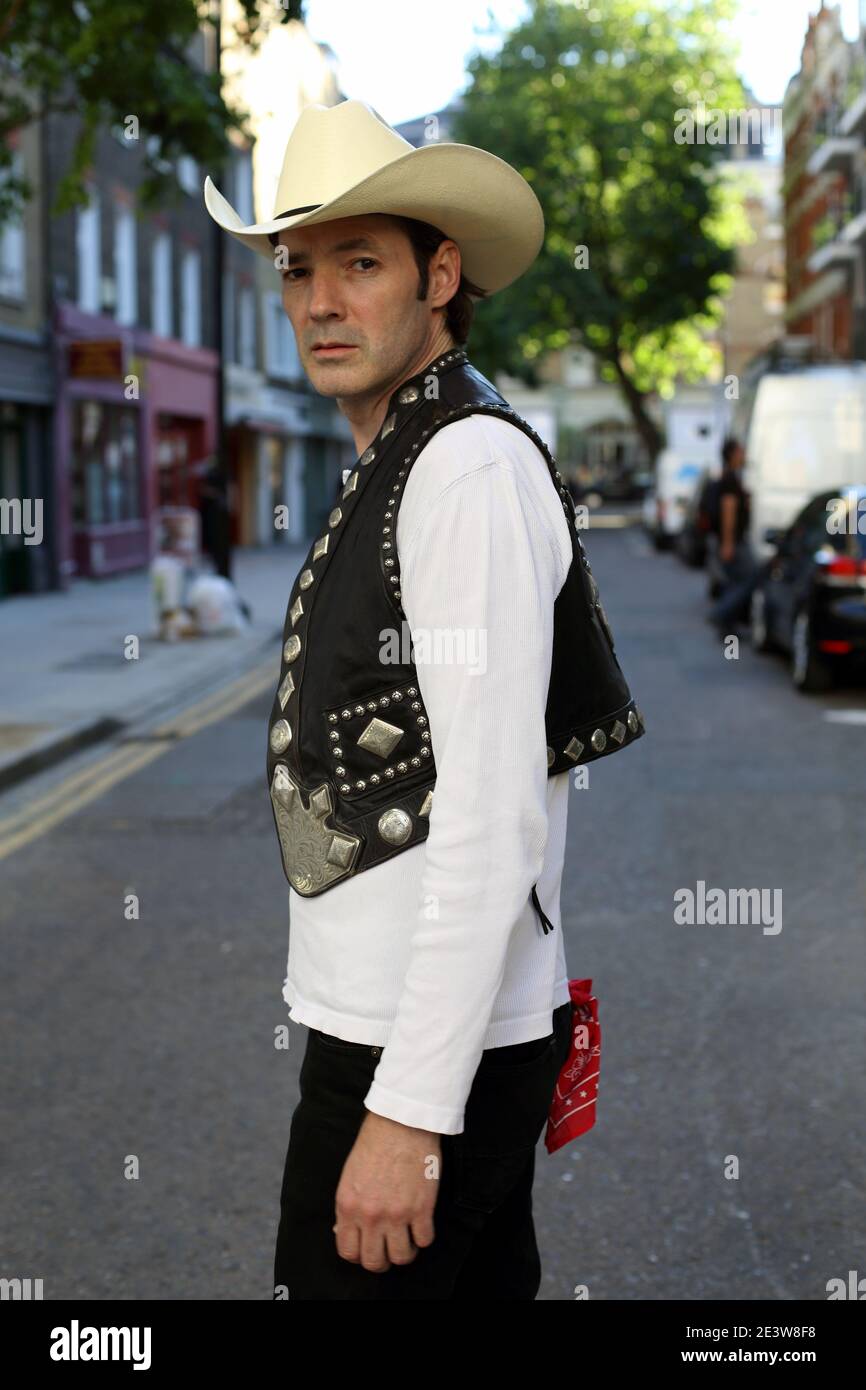 Portrait of stylish mid adult man wearing western out fit on street on ...