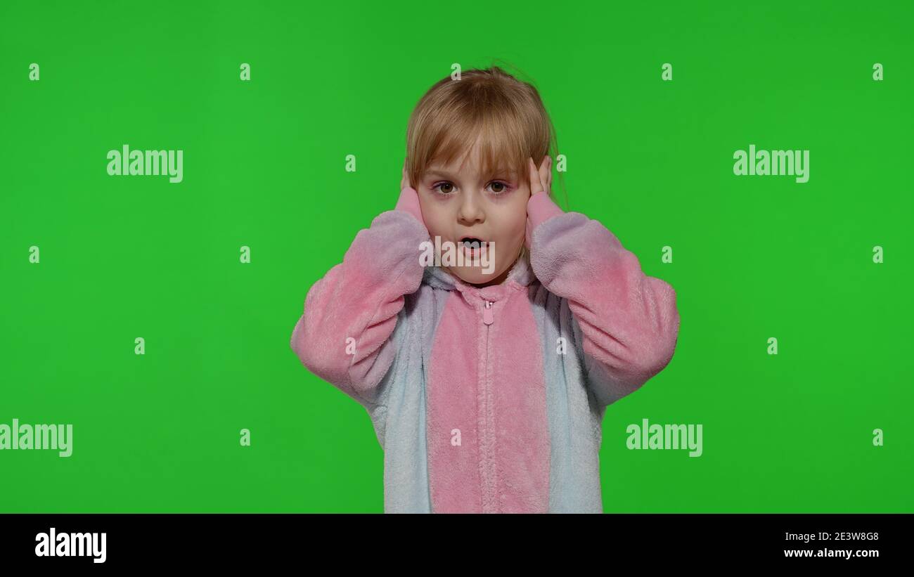 Portrait of happy amazed astonished young kid girl in unicorn costume ...