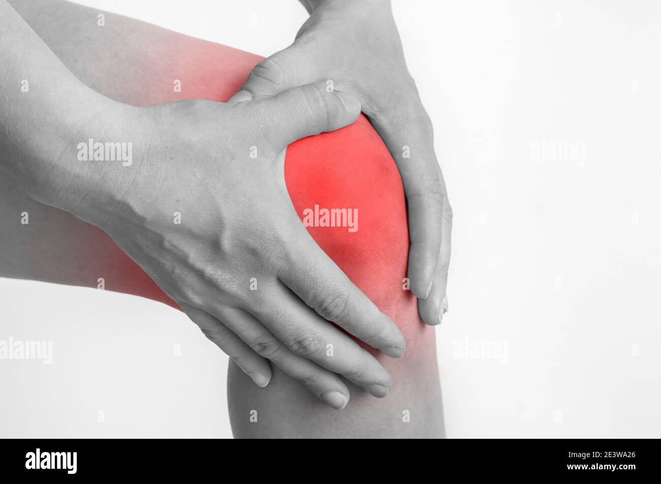 Woman with knee pain is holding her aching leg - black and white photo ...