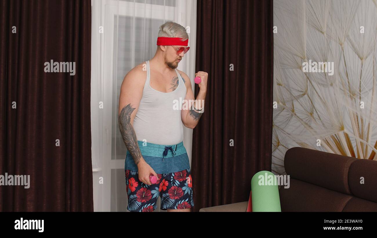 Funny fat sportsman man athlete in sportswear making sport fitness ...