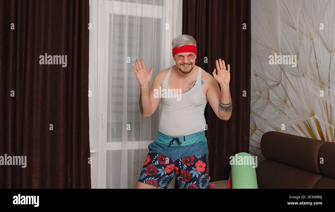 Hello or bye. Sportsman retro guy in funny sport clothes waving ...