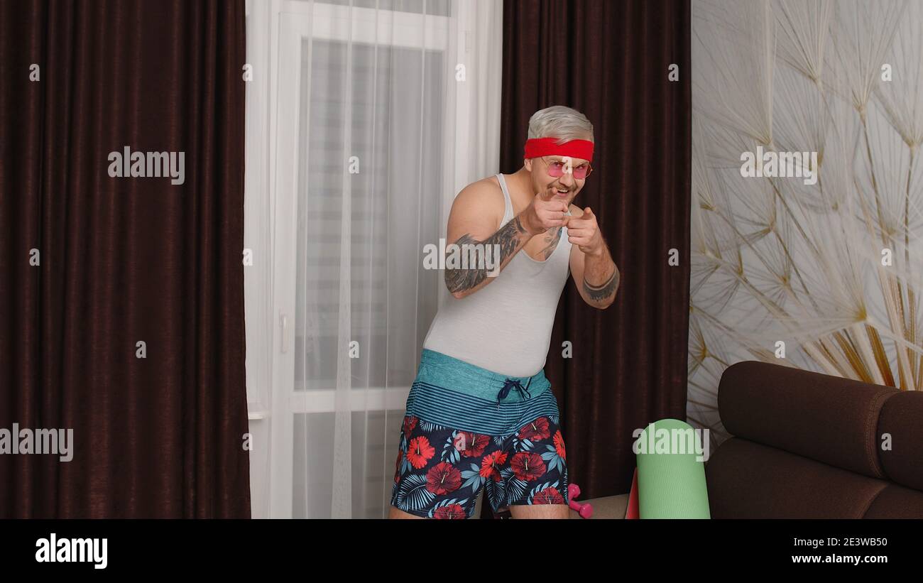 Sportsman retro guy in funny clothes dancing, pointing at camera ...