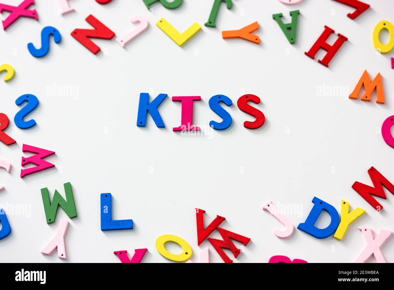 Kiss - a word of multicolored letters on a white table, Flat Lay ...