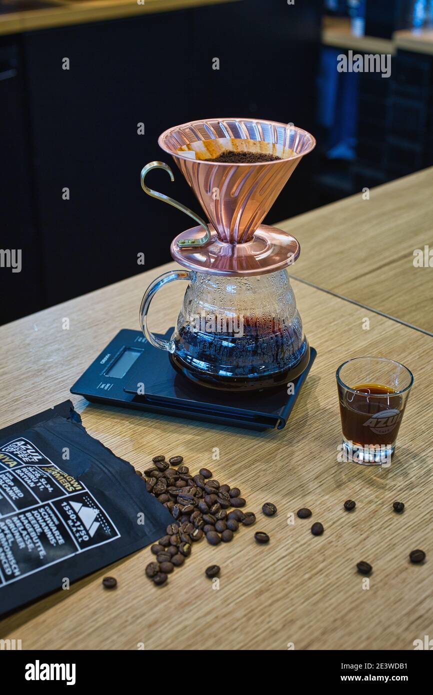 Closeup image of coffee grounds in paper filter on digital coffee scale ...