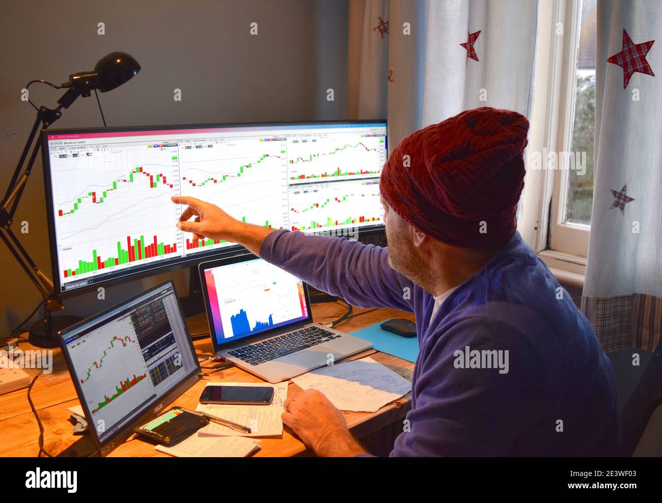 Online trader is showing charts movement on a large screen Stock Photo ...