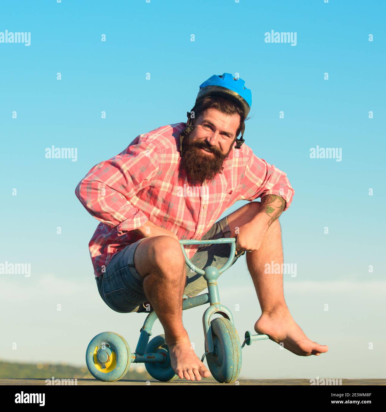 Funny biker, bicycle rider. Comic man ride bike Stock Photo - Alamy