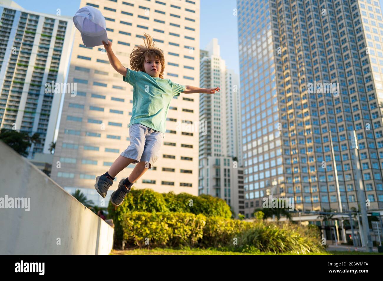 Child fun outdoor. Little boy jump on city street Stock Photo - Alamy
