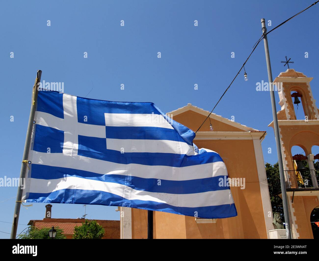 Greek flag flying outside church in Xanthates, Corfu, Greece Stock ...