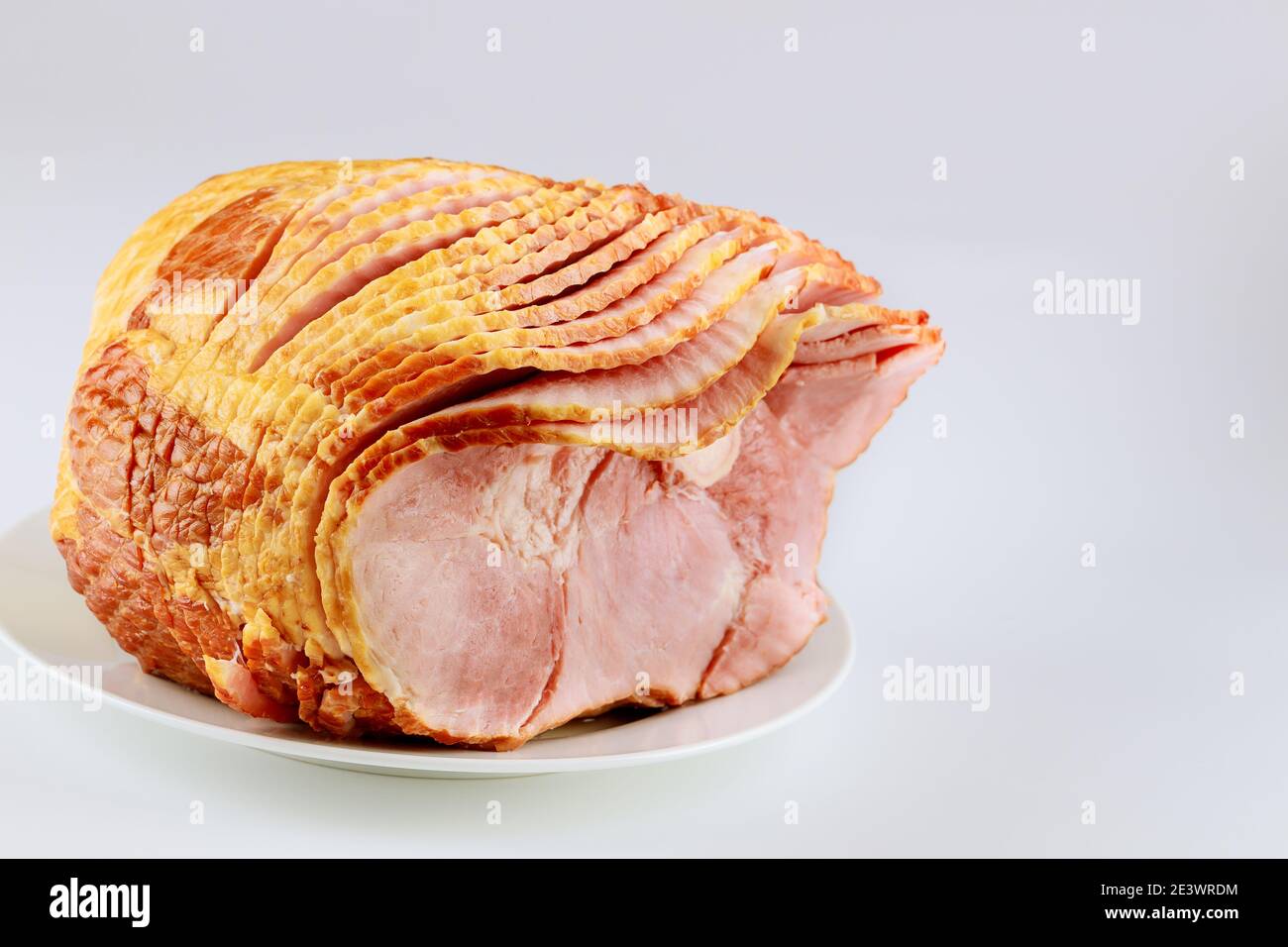 Spiral sliced pork ham isolated on white background. Holiday food Stock ...