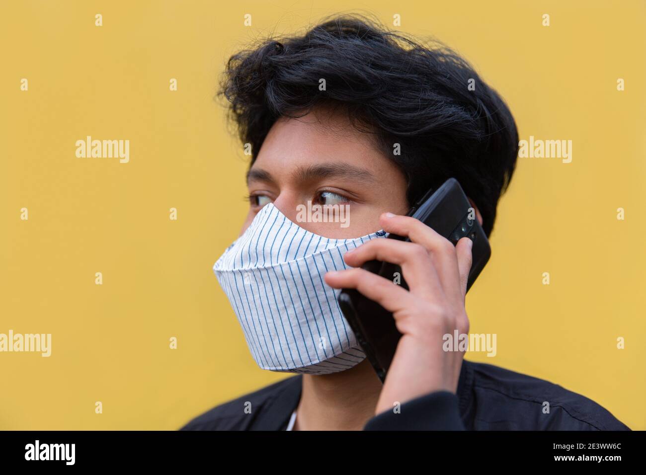 Latin young man mask walking hi-res stock photography and images - Alamy