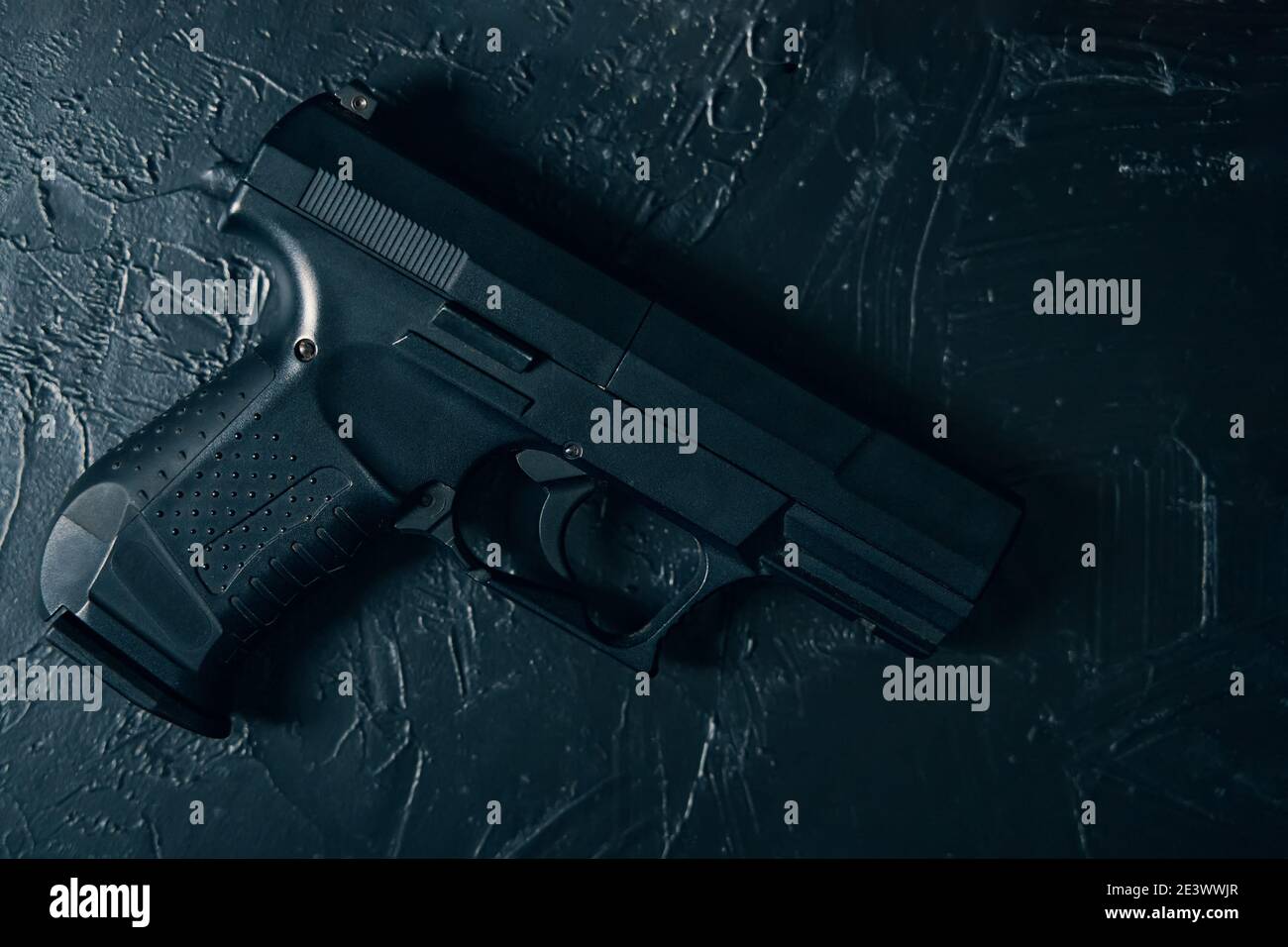 Pistol on green concrete texture table. Ammunition of law enforcement ...