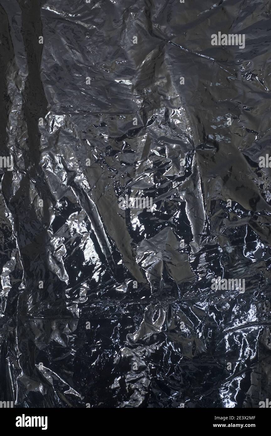 Grunge plastic wrapping background on black Stock Photo - Alamy