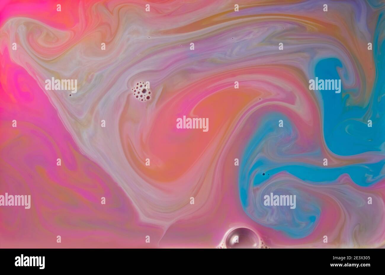 Colored liquids mixed together in fluid creating colorful abstract ...