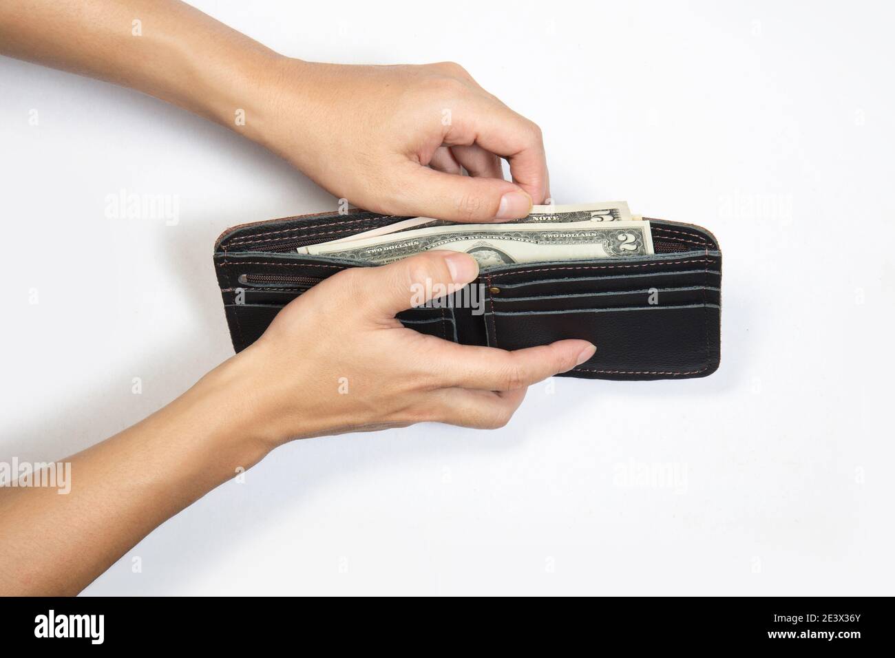 Hand pick up us dollars from the leather wallet isolated on white ...