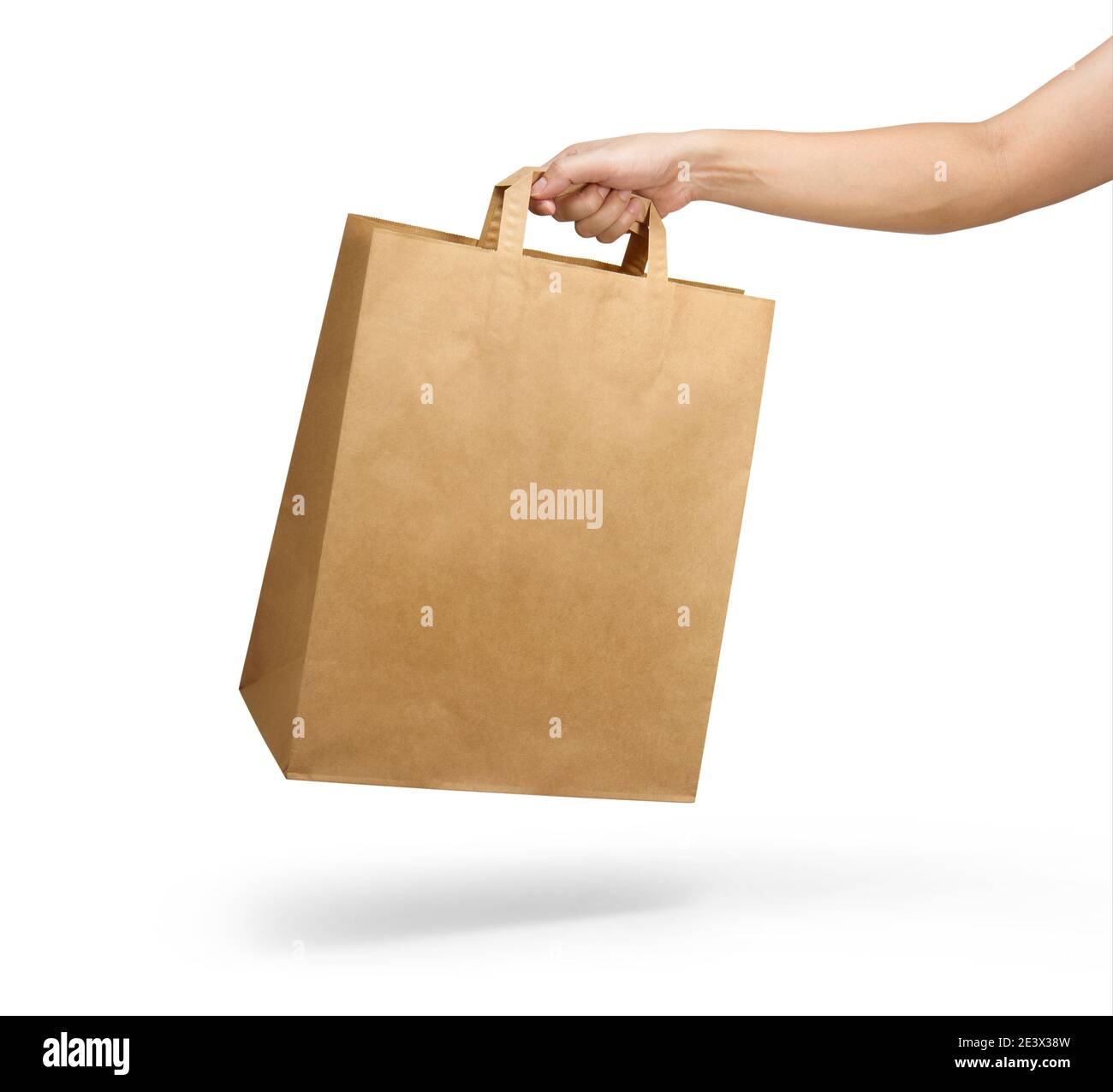 Right hand holding a brown paper bag with handle isolated on white ...