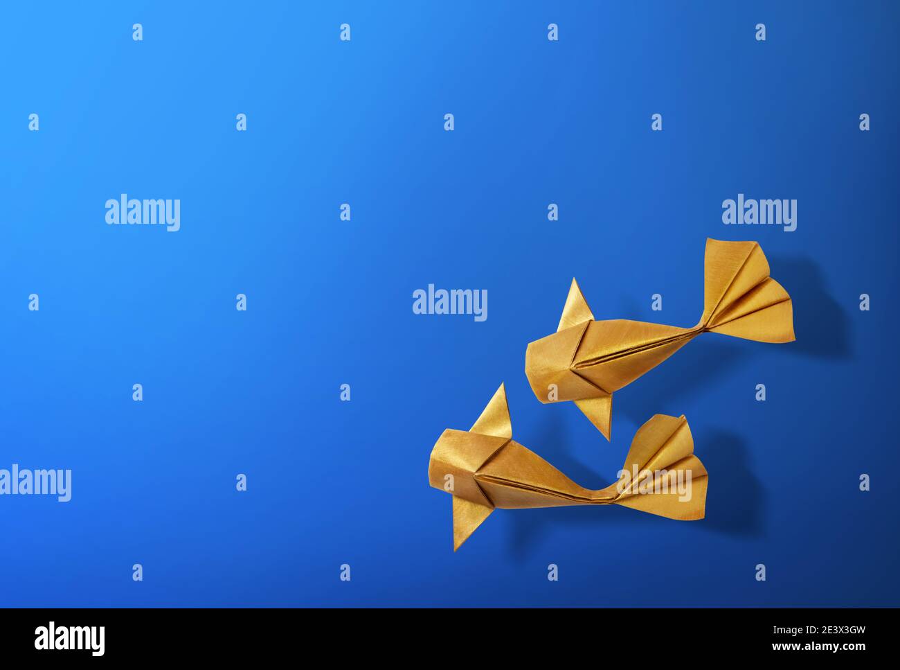 Handmade paper craft gold color origami koi carp fish on blue ...