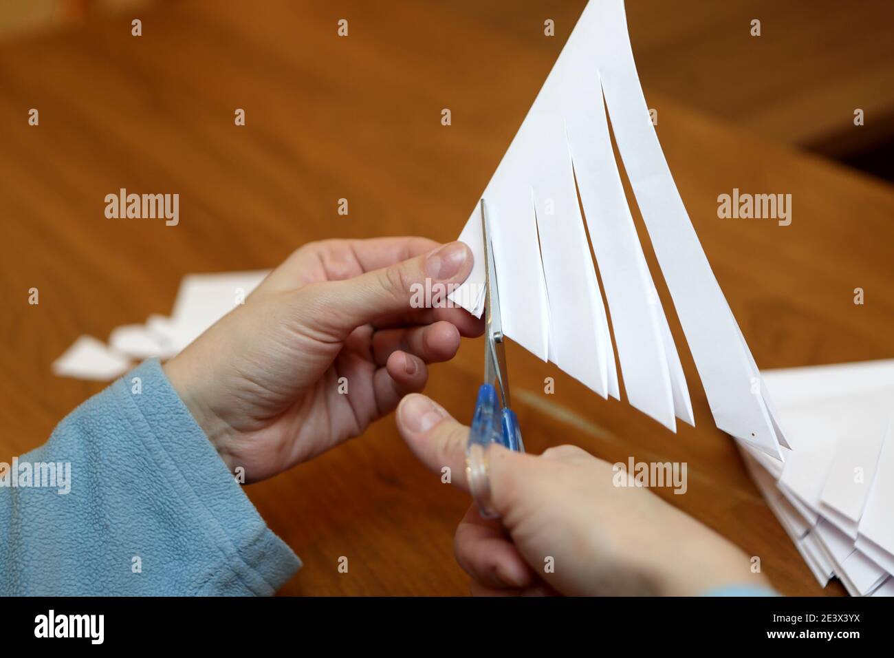 A person making paper snowflakes at workshop Stock Photo - Alamy